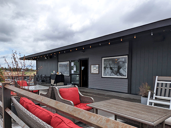 Outdoor seating with a view! Those red cushions aren't just inviting &ndash; they're practically shouting "Coffee break with a side of Central Oregon majesty!"