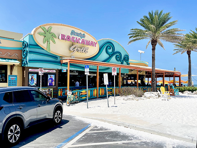 The iconic wave-inspired facade of Frenchy's Rockaway Grill welcomes beach-goers with its vibrant colors and promise of seafood paradise.