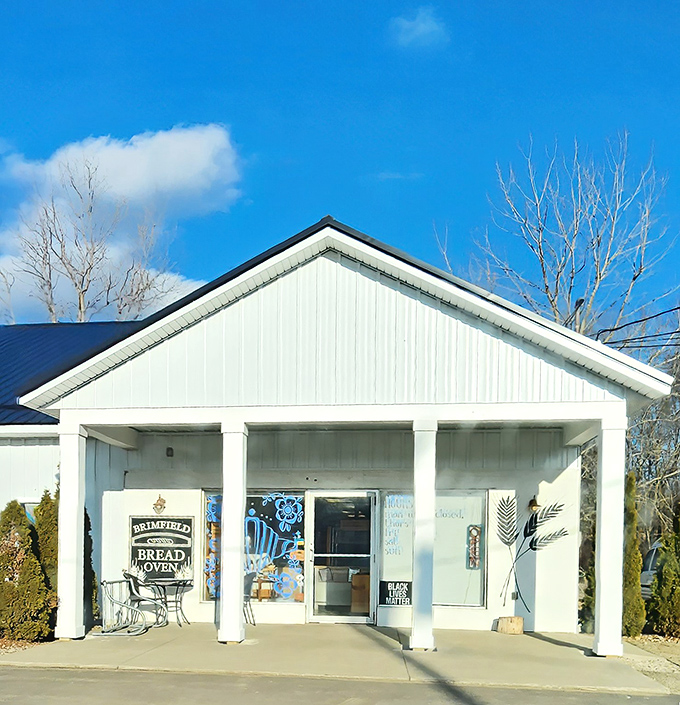 The unassuming white farmhouse exterior hides culinary magic within. Like finding Narnia in your neighborhood, but with better carbs.