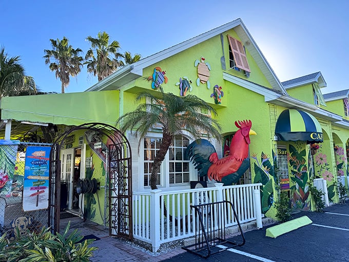 Palm trees frame the cheerful lime-green cottage where colorful fish sculptures and a proud rooster announce Florida's favorite brunch spot.