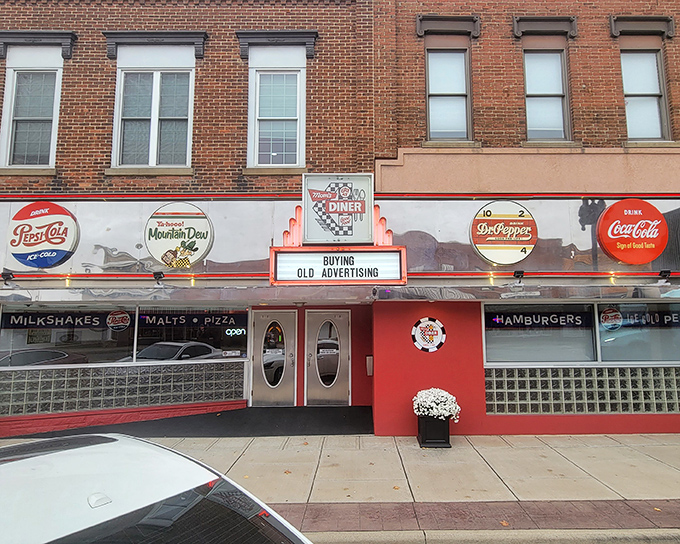 The classic red-and-white fa&ccedil;ade of Mom's Diner & Pizzeria stands as a beacon of comfort food in downtown Archbold, where vintage soda signs promise nostalgic flavors inside.