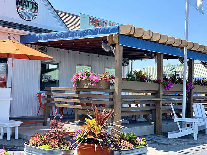 The coastal charm hits you before the first bite &ndash; Matt's Fish Camp's flower-adorned exterior promises seafood magic under that blue pergola.