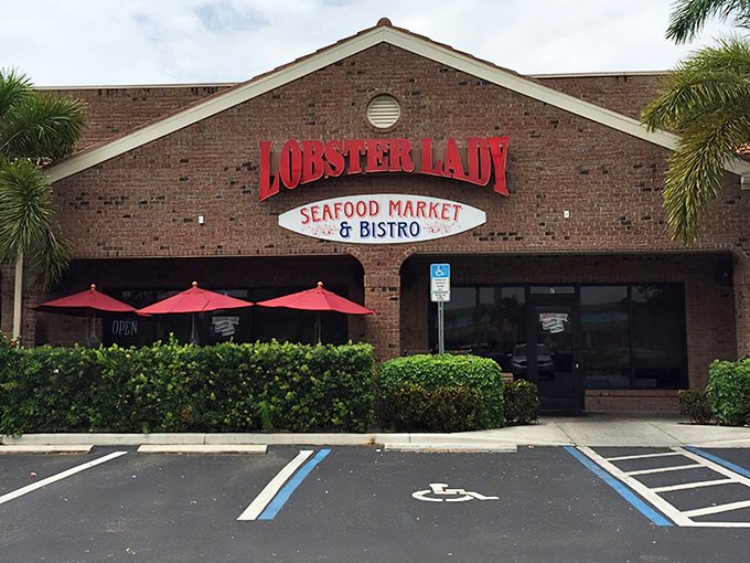 The glowing red sign of Lobster Lady beckons seafood pilgrims like a lighthouse for the gastronomically adrift, promising a feast worth the journey.