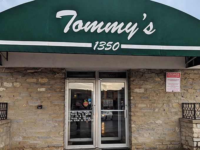 Tommy's iconic green awning stands as a beacon of pizza perfection in Columbus, promising authentic flavors without the frills.