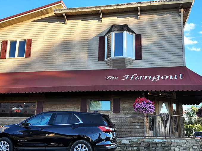 The Hangout's modest exterior with its burgundy awning promises no frills, just thrills for your taste buds. Small-town charm at its finest.
