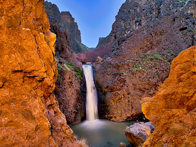 Nature's perfect frame &ndash; rugged canyon walls showcase the 60-foot cascade as it plunges into a serene pool below.