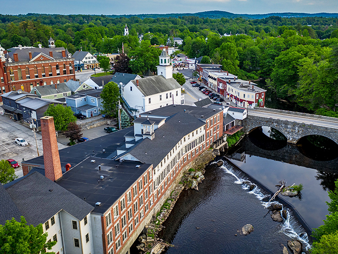 The stone arch bridge and converted mill buildings tell stories of Milford's industrial past, while the surrounding forest promises adventures just beyond town limits.