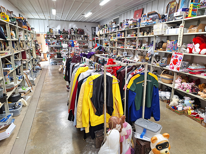 Treasure hunter's paradise! Racks of colorful jackets create a vibrant textile canyon between shelves overflowing with knickknacks and nostalgic collectibles.