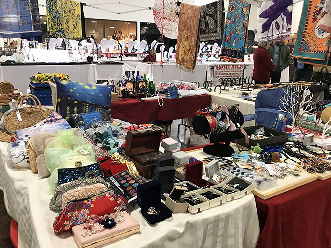 Treasure hunter's paradise! Tables overflow with colorful trinkets, jewelry, and collectibles waiting to reveal their stories to the right buyer.