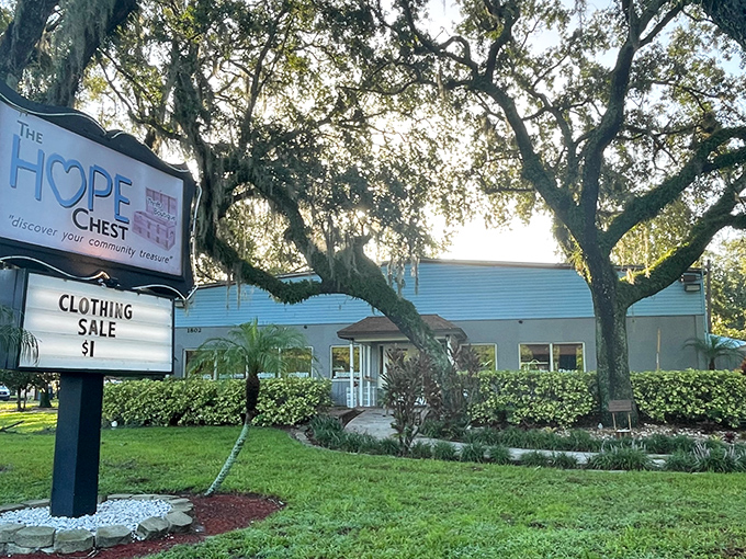 Nestled under majestic oak trees, The HOPE Chest welcomes bargain hunters with its cheerful blue sign and promise of $1 clothing treasures.