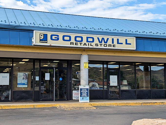 The Golden Goodwill stands ready for treasure hunters, its blue awning promising adventures in secondhand shopping.