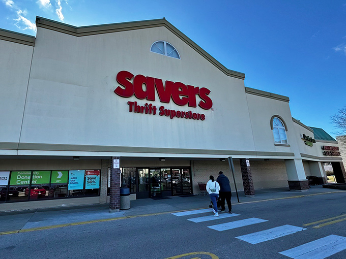 Under clear blue skies, Savers stands ready for another day of bargain hunting, with its donation center visible on the left.
