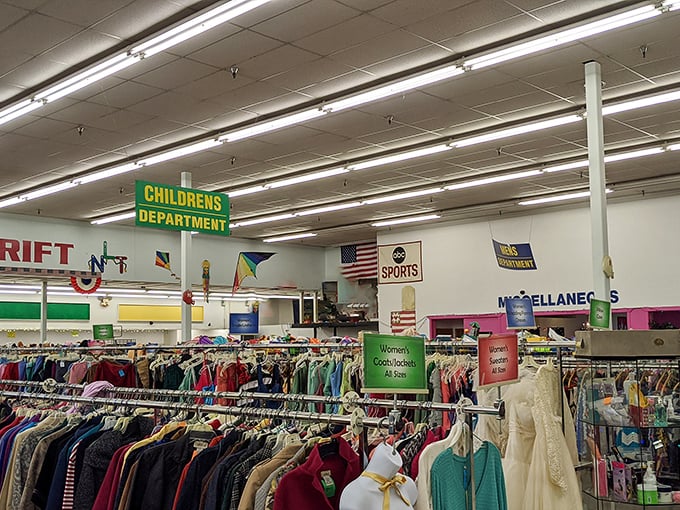 The bold red and teal signage of New Life Thrift Store beckons bargain hunters like a lighthouse for the frugally fashionable.