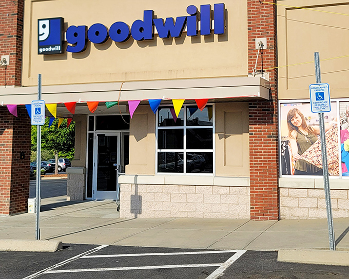 The colorful pennant flags outside this Goodwill welcome shoppers like a carnival of bargains waiting to be discovered inside.