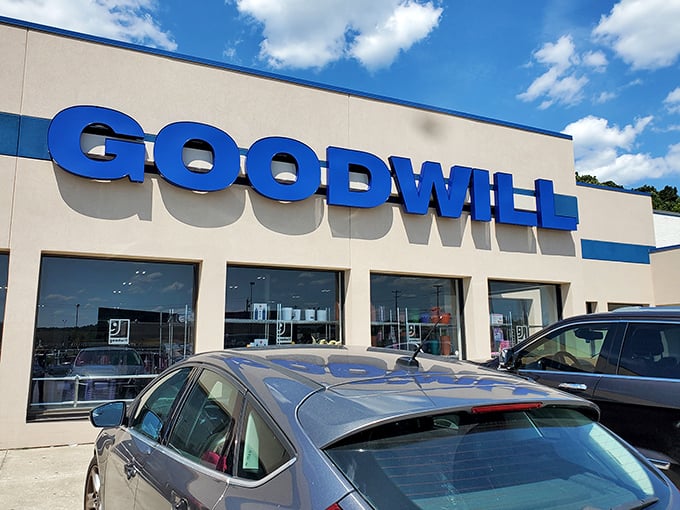 The blue Goodwill sign stands out like a beacon for bargain hunters, promising treasures within that won't break the bank.