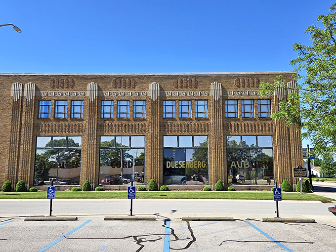 The Art Deco façade isn't just showing off—it's announcing that automotive royalty lives here. Those vertical lines practically scream "the Roaring Twenties never ended!"