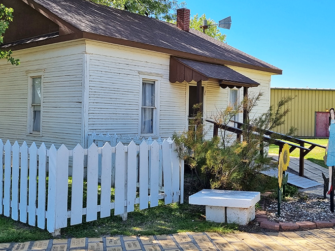 Dorothy's iconic white farmhouse stands proudly behind its picket fence, where the yellow brick road begins and Kansas dreams take flight.
