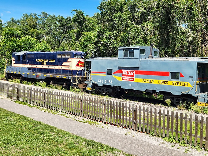 The Florida Gulf Coast locomotive stands proudly alongside a Family Lines System caboose, like old friends sharing stories of rails traveled and horizons chased.