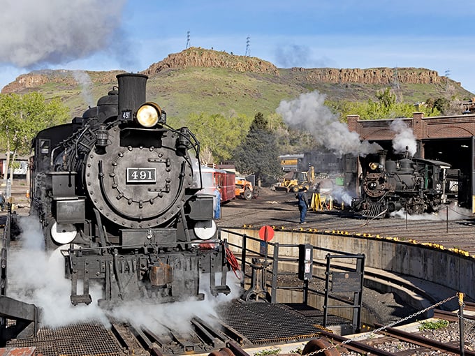 Steam billows dramatically as Engine No. 491 commands the spotlight, with North Table Mountain providing a backdrop worthy of a classic Western film.