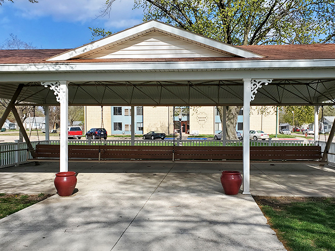 The World's Largest Covered Porch Swing beckons with its pristine white pavilion and warm wooden bench&mdash;Nebraska's charming answer to the question "What if relaxation had a monument?"