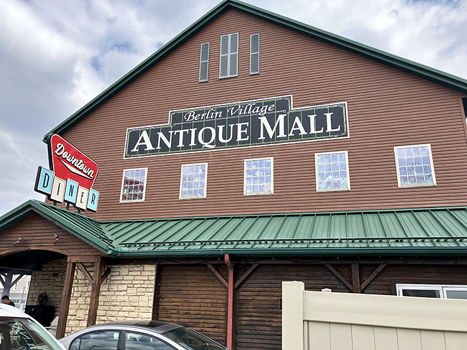 The barn-like exterior of Berlin Village Antique Mall promises treasures within, like a rustic Tardis of timeless collectibles waiting to be discovered.