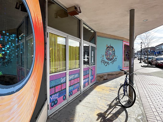 The vibrant, mural-adorned exterior of Global Thrift beckons like a treasure chest waiting to be opened. Even the bicycle seems to know this is the place to be.