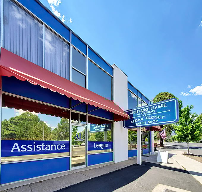 The blue and red exterior of Cedar Closet Thrift Shop stands like a beacon of bargain possibilities under Arizona's brilliant sky. Happy hunting awaits!
