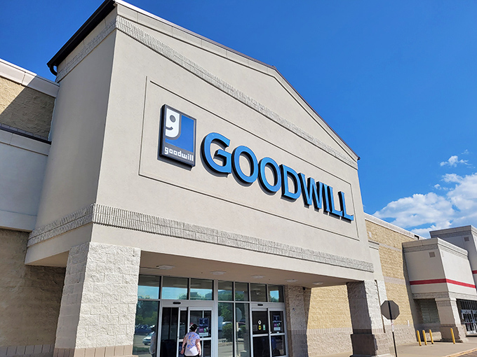 The iconic blue Goodwill sign stands proudly against Colorado's perfect sky, beckoning bargain hunters like a thrift store lighthouse.