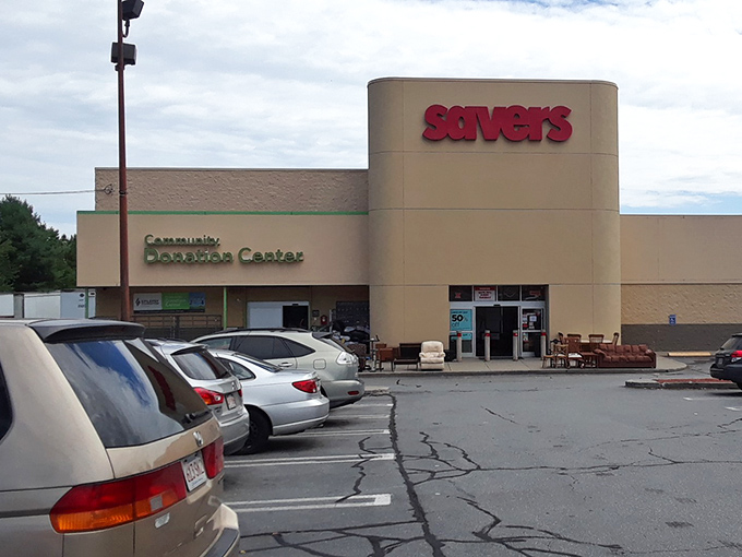 The bold red Savers sign shines like a beacon for thrifters, guiding bargain hunters with empty closets toward a haven of secondhand treasures.