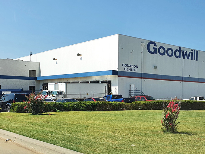 The unassuming exterior of Oklahoma City's Goodwill Outlet belies the treasure-hunting adventure waiting inside. Blue skies and opportunity await.