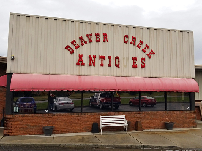 The iconic red lettering against cream-colored siding promises treasures within. That white bench isn't just decorative&mdash;it's for when your shopping companions need a breather!