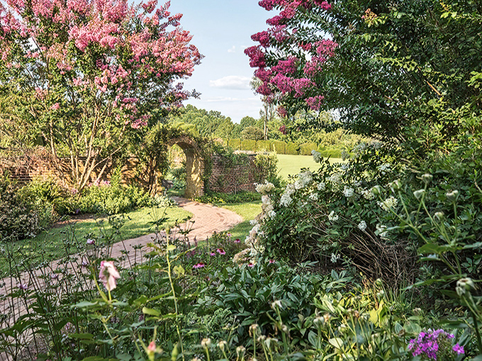 Secret garden pathways beckon explorers through a flowering archway, promising discoveries that would make Frances Hodgson Burnett swoon.