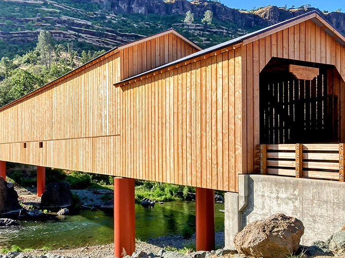 Golden-hued timber stretching across Butte Creek like nature's perfect postcard. The bridge's warm wooden tones practically glow in the California sunshine.