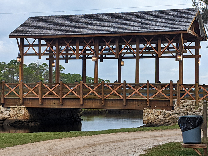 The Princess Place Covered Bridge creates a perfect reflection in the still waters below, like nature's own Instagram filter working its magic.
