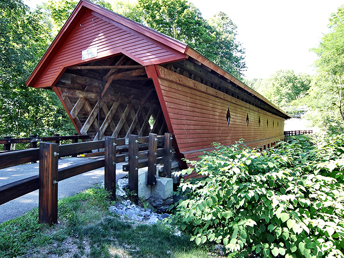 Like a crimson sentinel standing guard over the stream below, the Newfield Covered Bridge combines rustic charm with engineering ingenuity that's lasted generations.