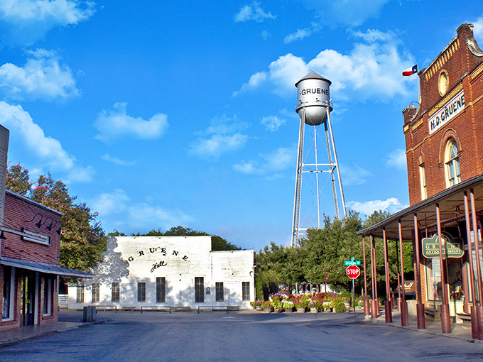 The iconic Gruene water tower stands sentinel over historic buildings, where time slows down and small-town Texas charm cranks up to eleven.