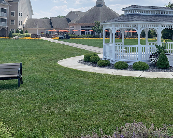 The classic white gazebo stands like a wedding cake centerpiece, inviting visitors to pause and soak in Lake Erie's splendor.
