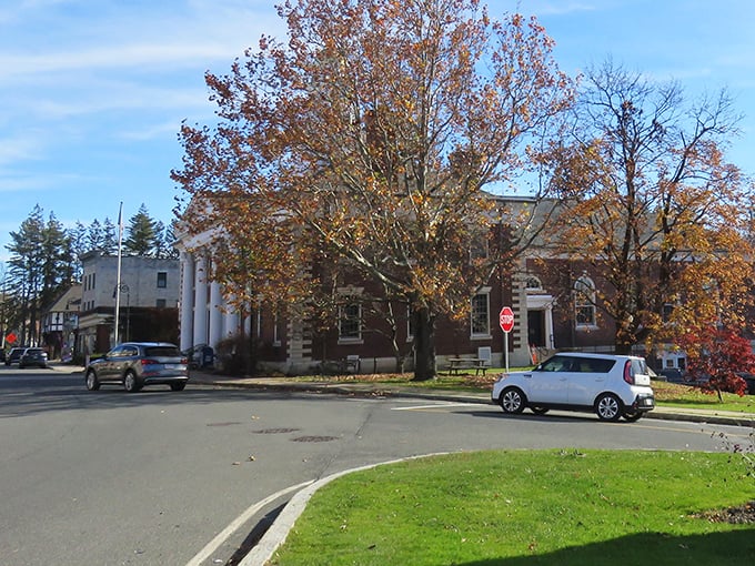 Lenox's historic buildings stand proudly amid autumn's fiery display, like architectural celebrities dressed in their seasonal best.