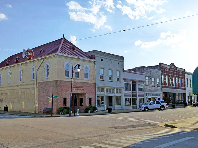 This corner of Corinth whispers stories from another era, where brick facades and angled parking create a Norman Rockwell painting come to life.