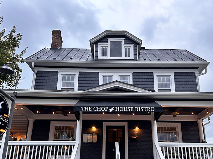 The charming navy blue exterior of Chop House Bistro beckons like a siren song to hungry travelers. This converted house promises culinary treasures within its welcoming walls.