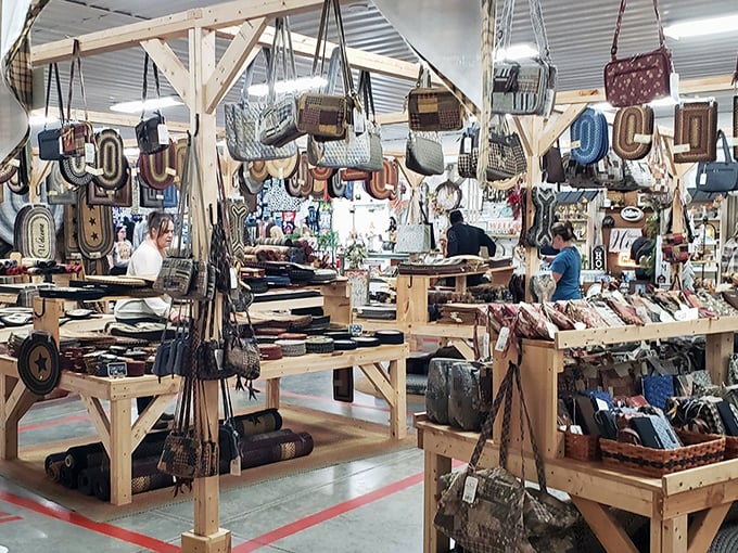 A leather lover's paradise where purses hang like exotic fruit from wooden beams, tempting you to touch every handcrafted treasure.
