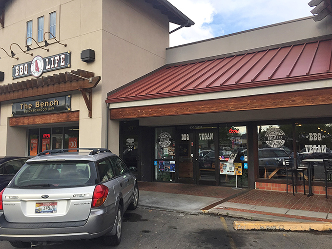 The rust-red roof and welcoming storefront signal that something special awaits inside this Boise barbecue haven.
