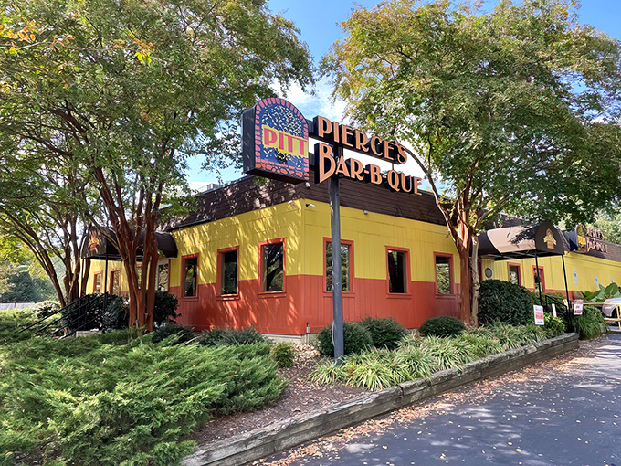 That unmistakable yellow and orange exterior stands like a barbecue beacon, promising smoky delights within Pierce's legendary walls.