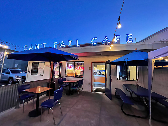 The neon-lit exterior of Rudy's Can't Fail Cafe stands as a beacon of comfort food in Emeryville, promising punk rock vibes and plates that satisfy.