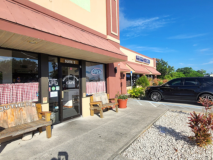 The unassuming exterior of Southern Charm Cafe beckons with rustic wooden benches and checkered curtains&mdash;like a Southern grandmother's invitation you can't refuse.