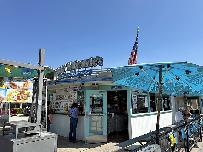 The turquoise beacon of taco paradise beckons from Ventura's shoreline, promising seafood salvation under those blue umbrellas.