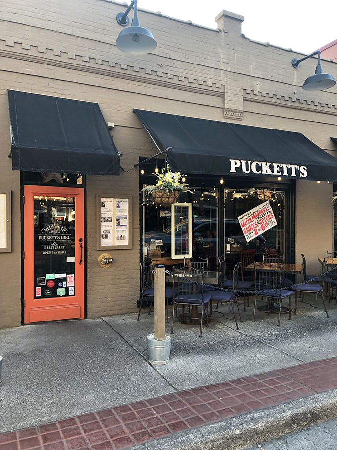 The classic black awnings and welcoming orange door say "come on in" louder than any neon sign ever could. Southern hospitality starts at the sidewalk.
