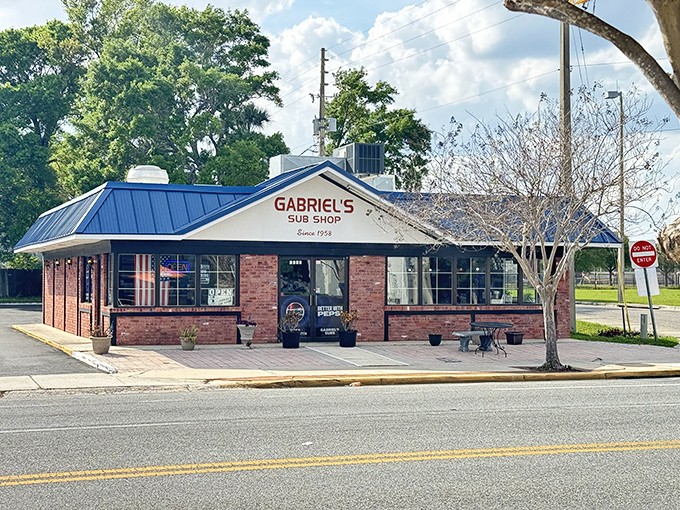 The iconic blue roof and brick facade of Gabriel's Sub Shop stands as a beacon of sandwich perfection in Orlando's College Park neighborhood.