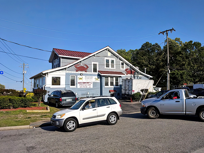 The blue siding and red roof of Wicker's stands out like a maritime flag, signaling to hungry travelers that seafood salvation awaits inside.