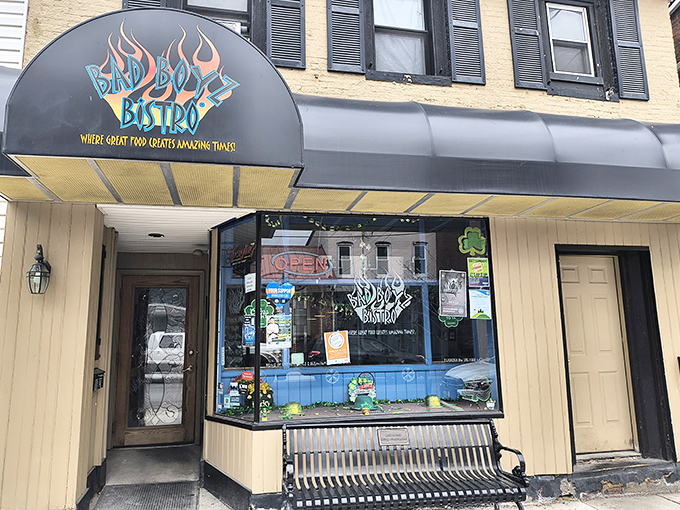 The iconic black awning of Bad Boyz Bistro beckons hungry travelers with its fiery logo and promise of "amazing times" in downtown Bedford.v
